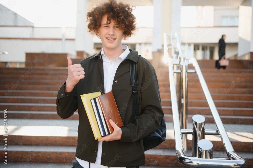 Excited student having break between classes near university, smiling ...