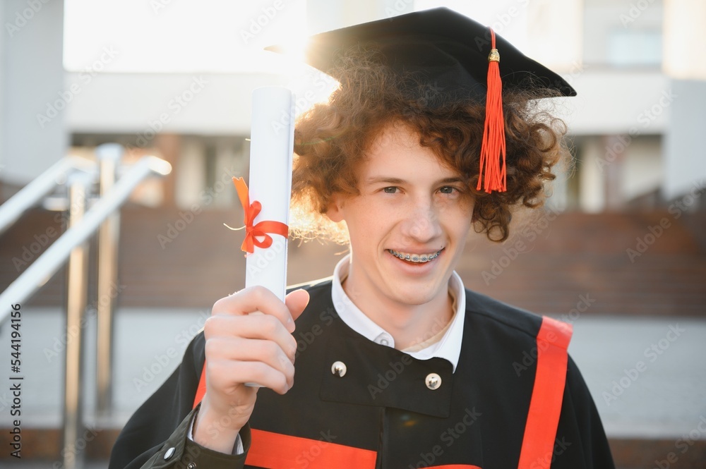 Graduation from university. Young smiling boy university graduate in ...