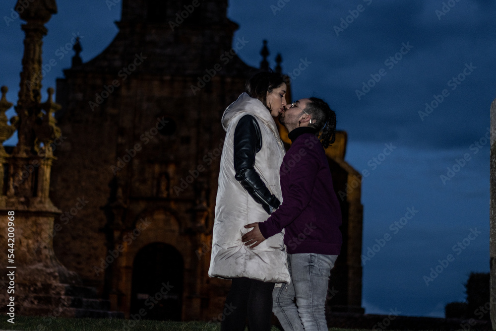 Attractive girl tenderly hugging her boyfriend outdoors. Woman hugging ...