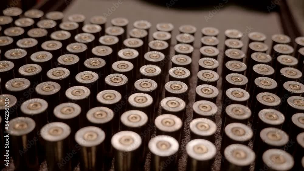Many rows of used cartridge cases with punched capsules from a rifle or ...