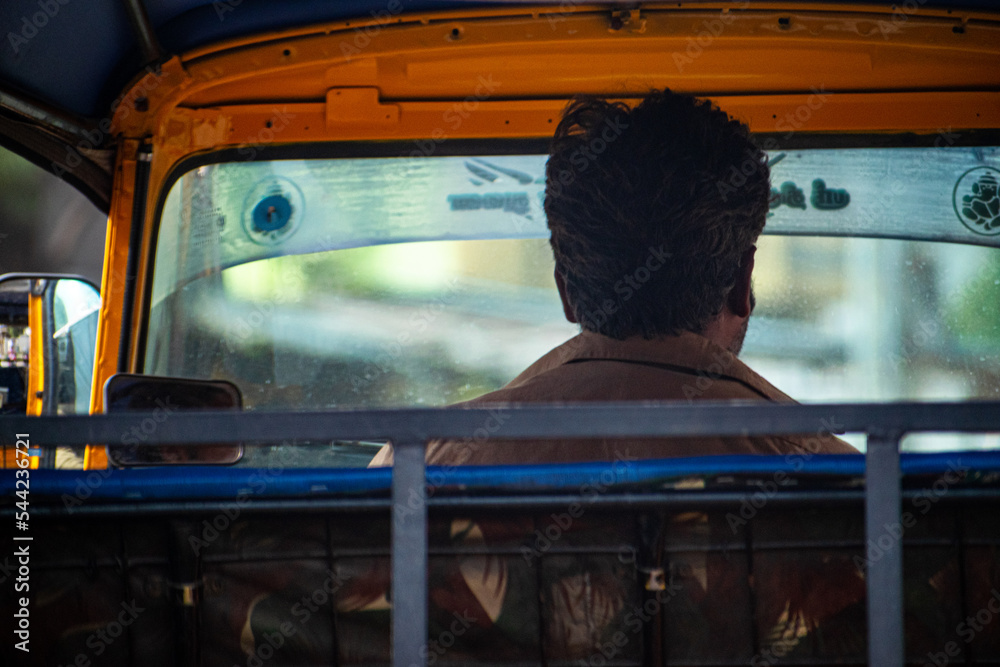 Auto rickshaw driver driving rickshaw on streets of India Stock Photo ...