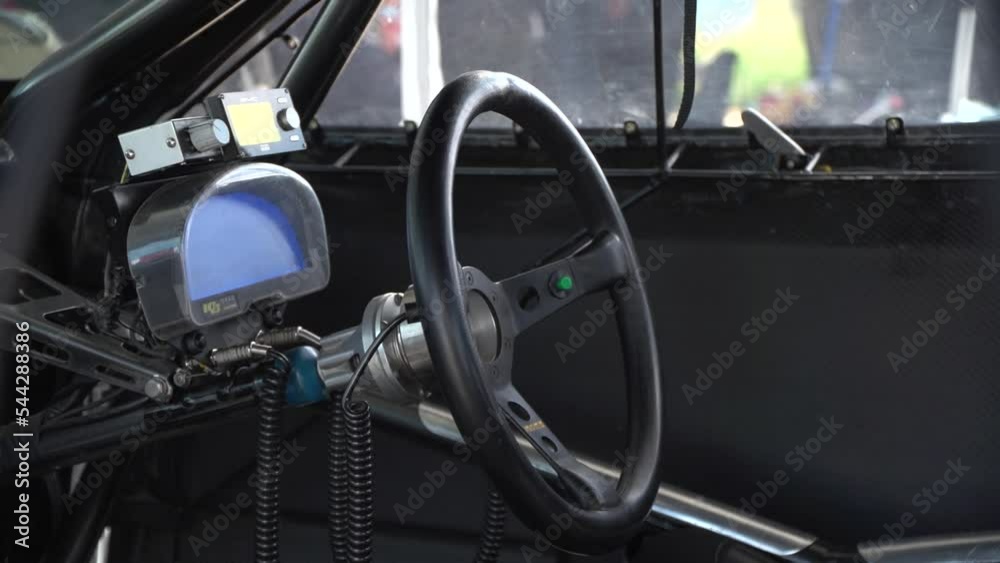 Middle shot of pilot seat inside the real drag racing car with steering ...
