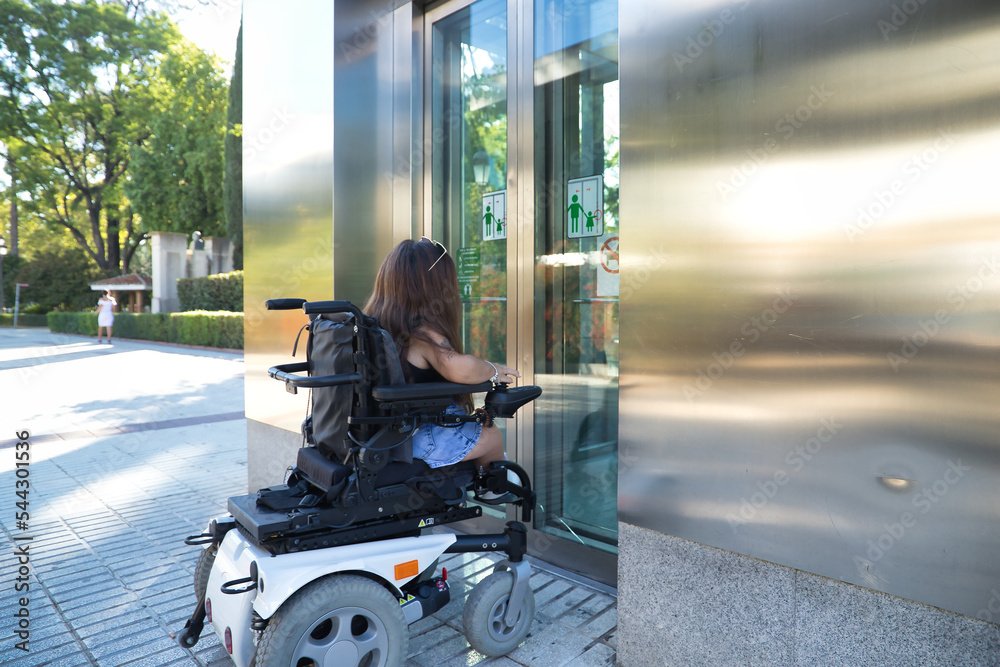 Disabled woman with reduced mobility and small stature in an electric ...
