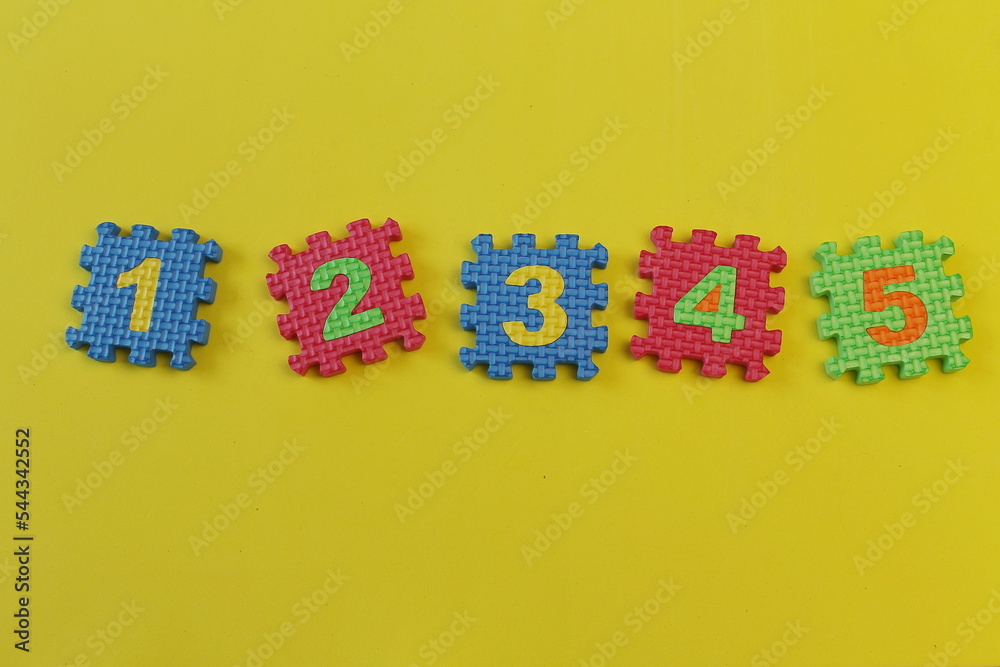 soft puzzles with numbers on a yellow background, colorful numbers one ...