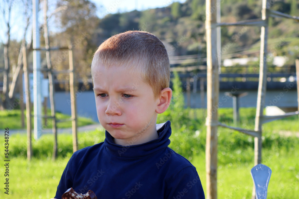 The short-haired, blond boy puffed out his cheeks and lowered his eyes ...