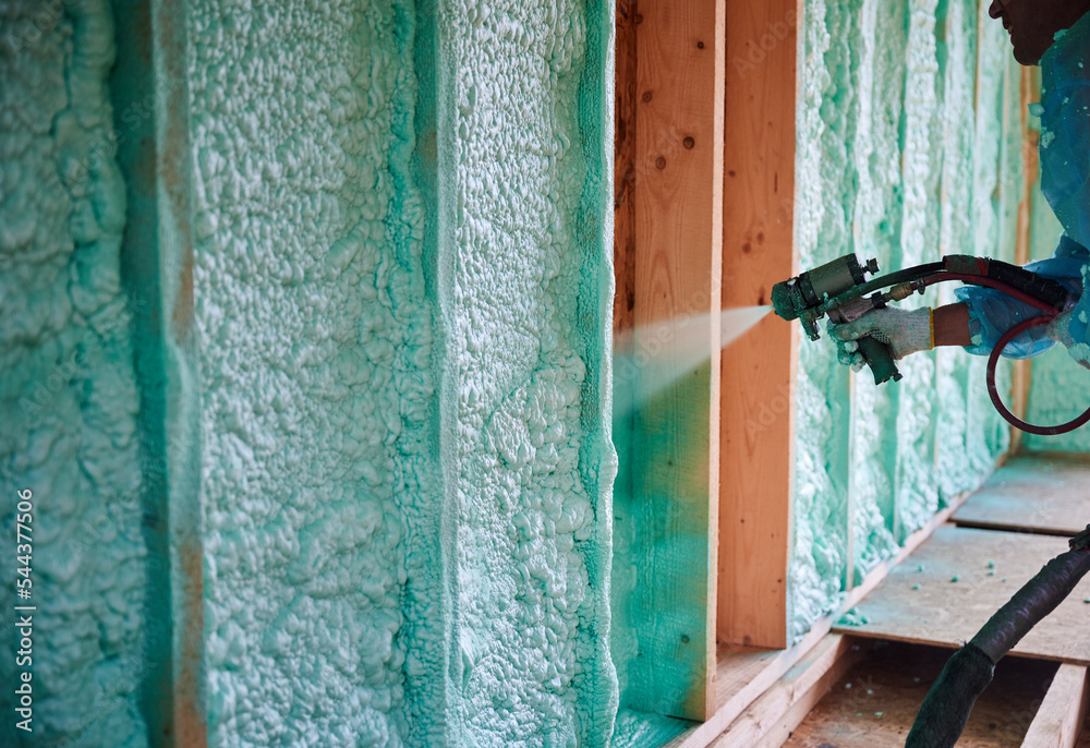 Builder insulating wooden frame house. Close up view of man worker ...