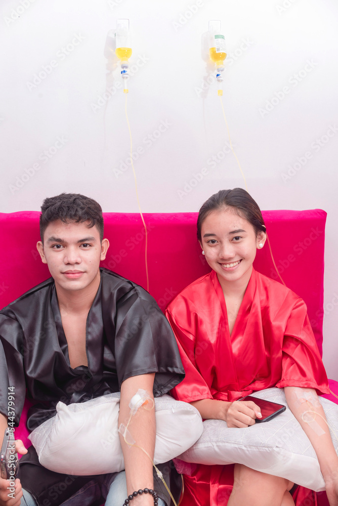 A male and female patient undergoing a Glutathione IV infusion therapy ...
