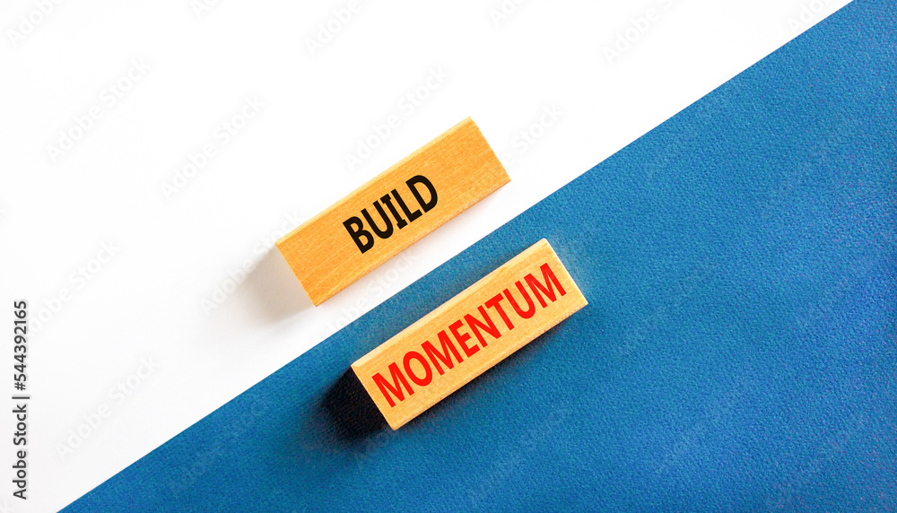 Build momentum symbol. Concept words Build momentum on wooden blocks ...
