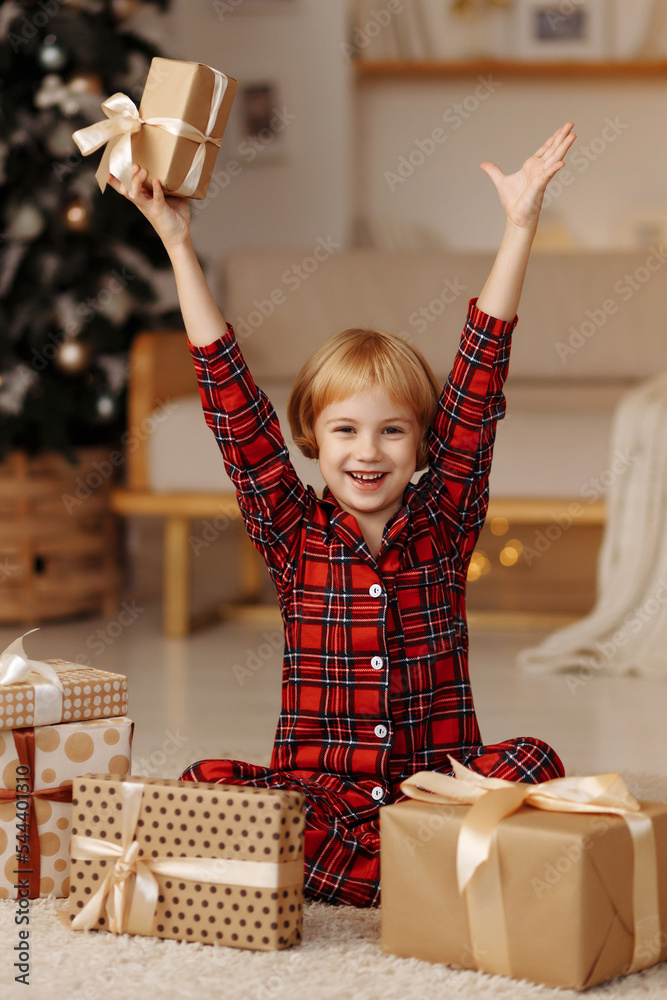 Girl sitting on the floor with a gift in a box Stock Photo | Adobe Stock