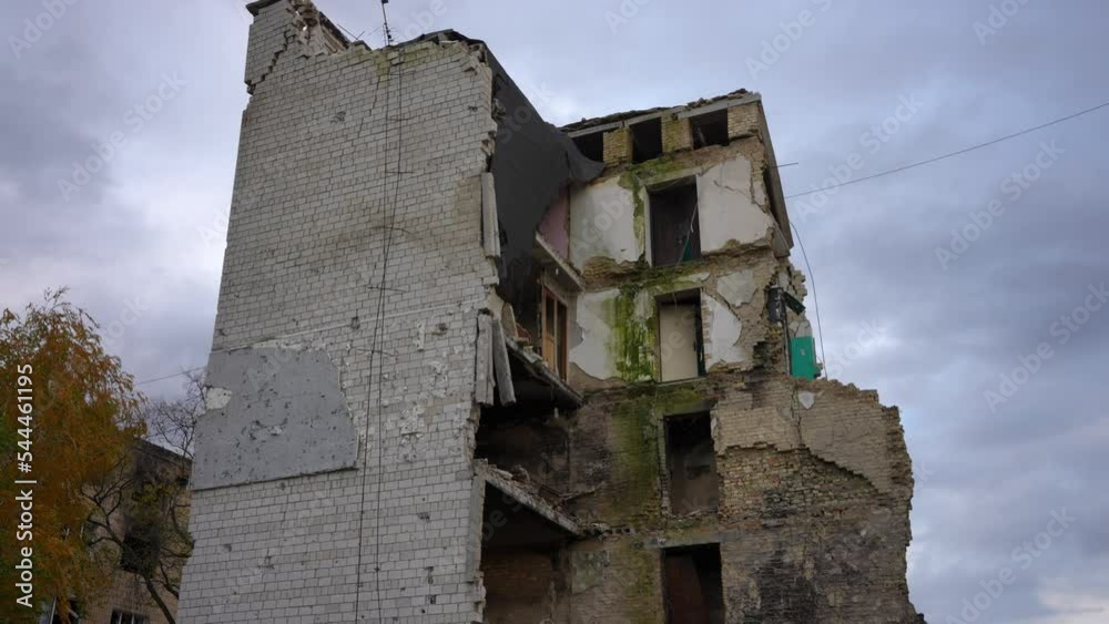 Ruined multi-storey building with walls missing outdoors at background ...