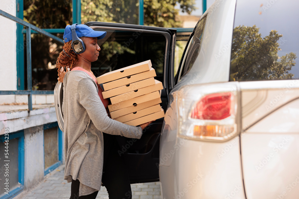 Office lunch delivery service worker delivering pizza by car, side view ...
