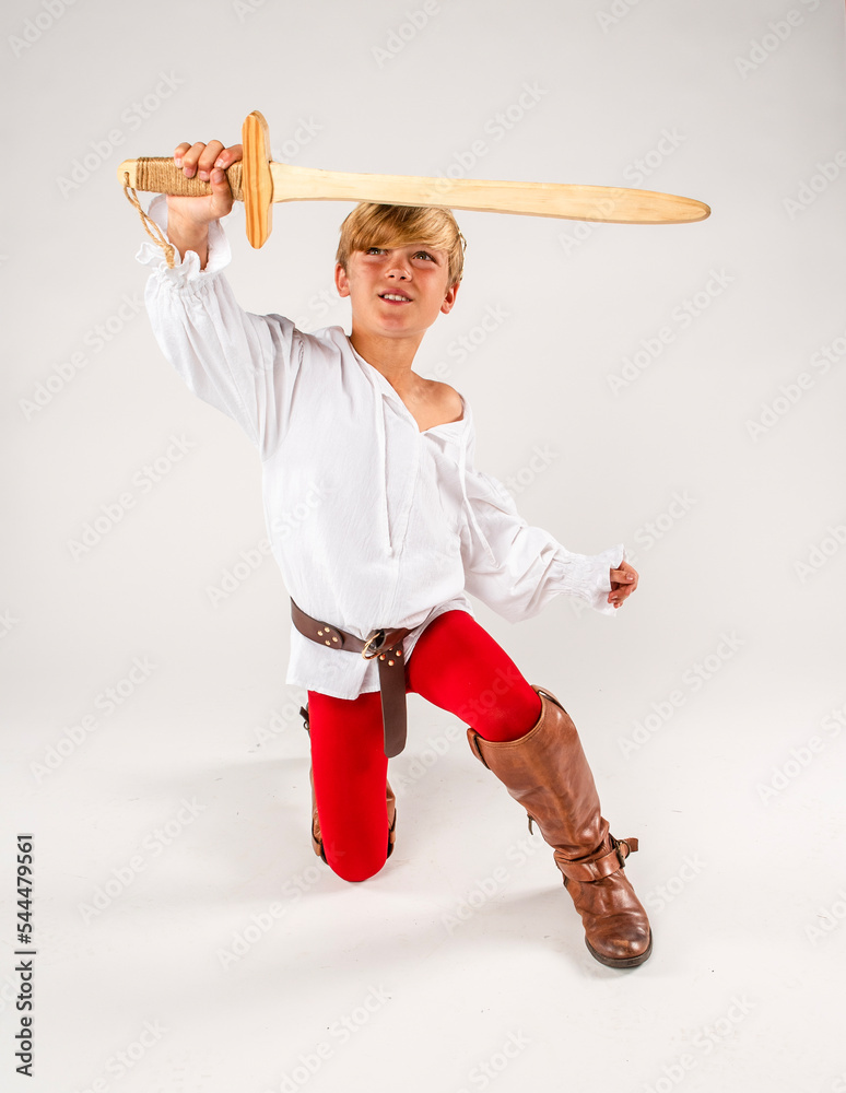 Young boy dressed as a warrior pretending to fight a monster with his ...