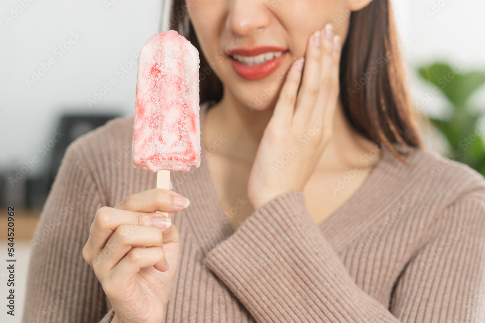 Foto de Face expression suffering from sensitive teeth and cold, asian ...