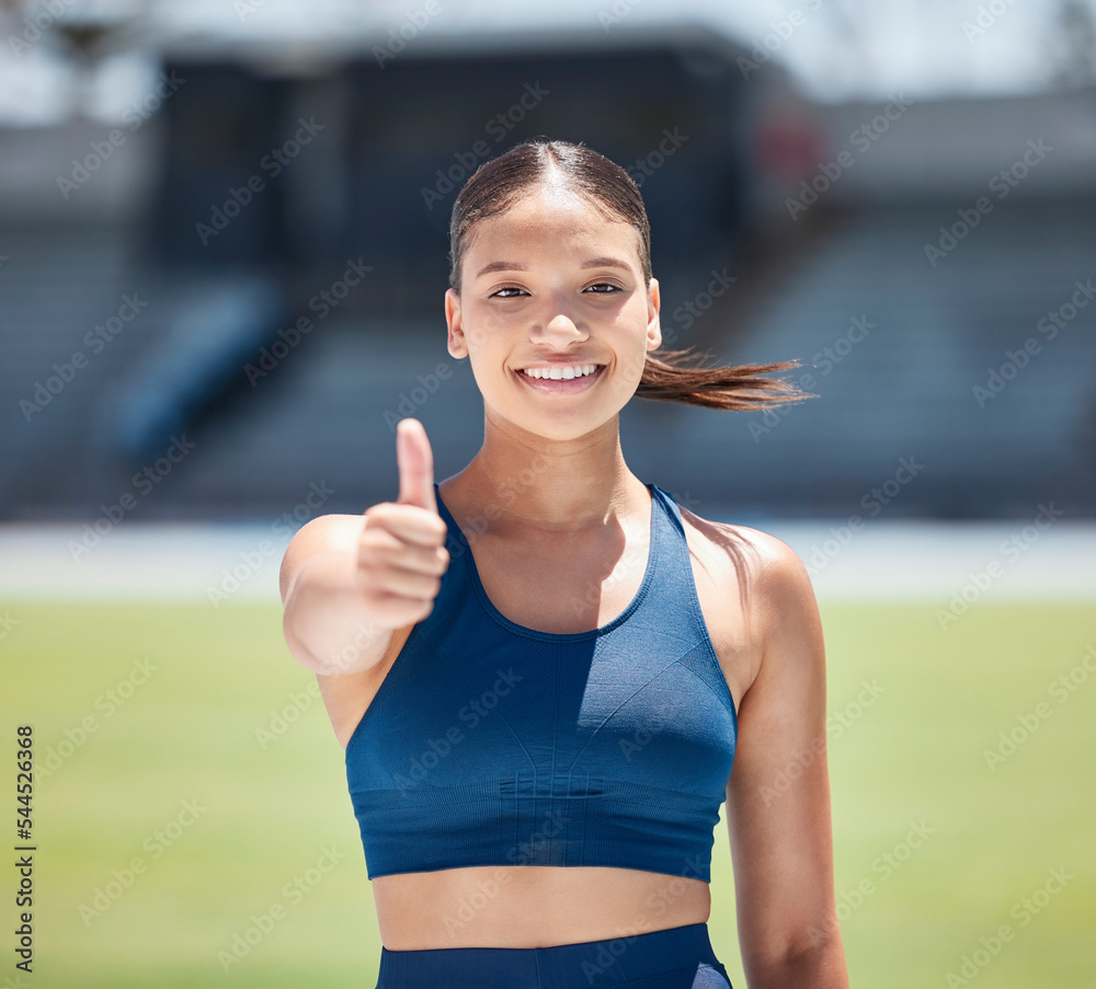 Thumbs up, woman athlete and portrait on stadium, running track and ...