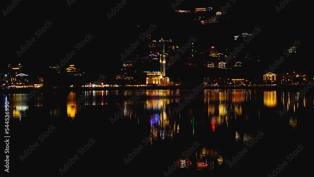 Night view of the mosque and its reflection in the water of the lake ...