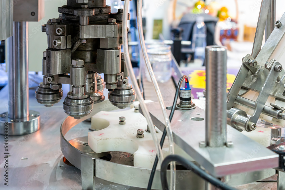 Close up capping head or sealing roller component of can cap seamer ...