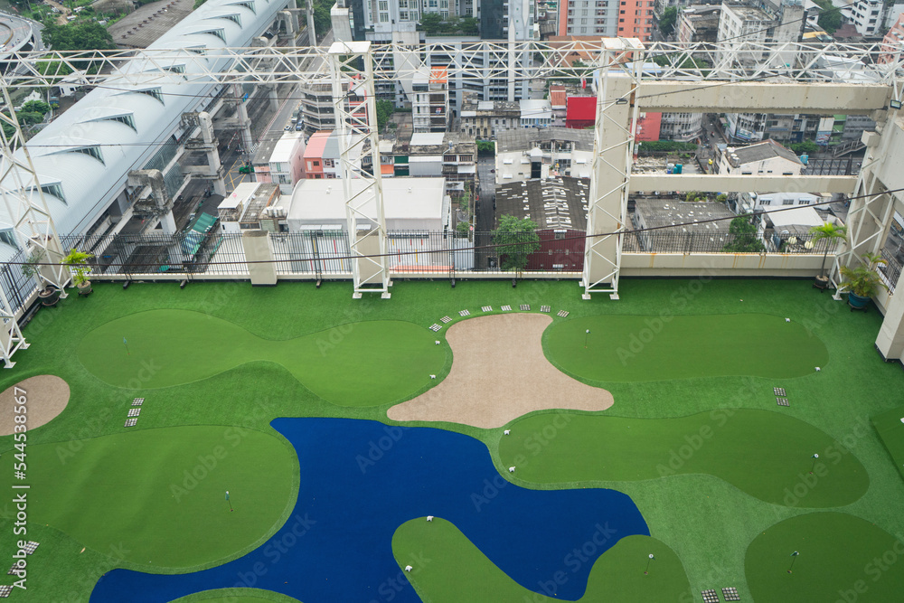 Small golf course of golf driving range on top of the roof with ...