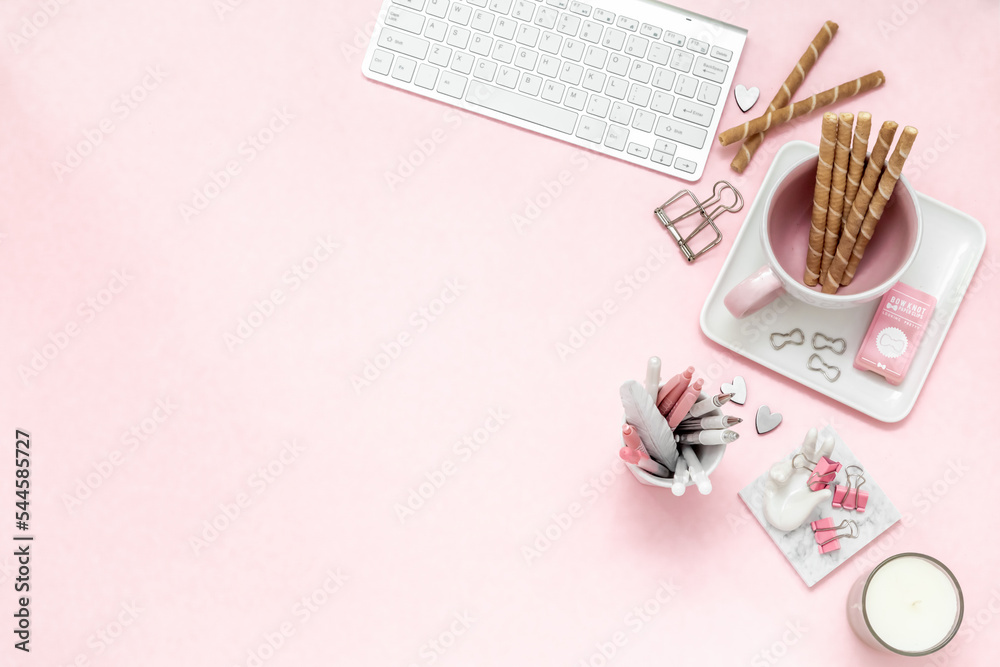 A feminine woman workspace, with a silver keyboard of a computer on a ...
