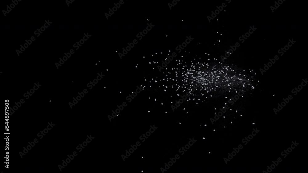 Debris from ground explosion with smoke and sand on a black background ...
