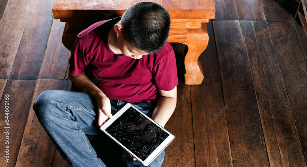 Portrait of a little Asian boy, Kid sad face, Unhappy child sitting holding broken tablet ...