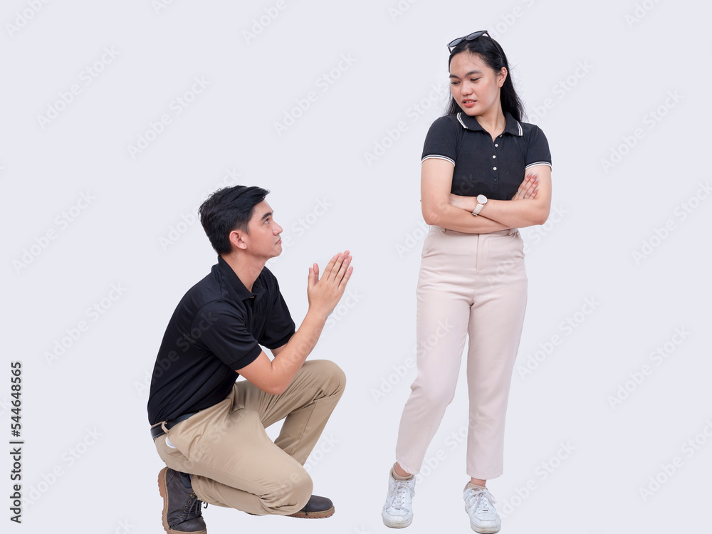 A man begs forgiveness from his upset girlfriend. Kneeling and pleading ...