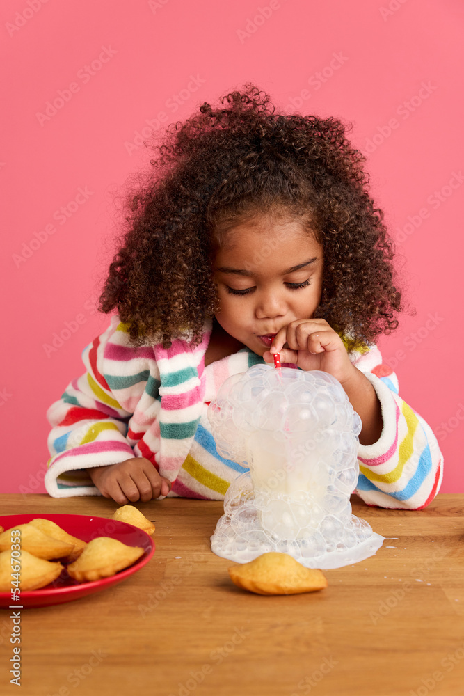 Little girl making mess with milk bubbles at breakfast table Stock ...