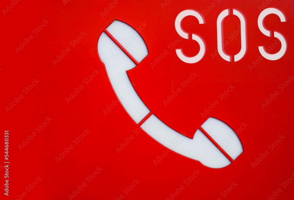SOS sign. Red flat phone icon, isolated on a red background ...