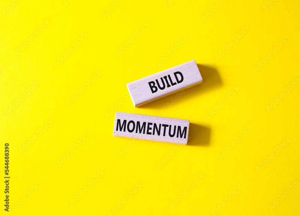 Build momentum symbol. Wooden blocks with words Build momentum ...