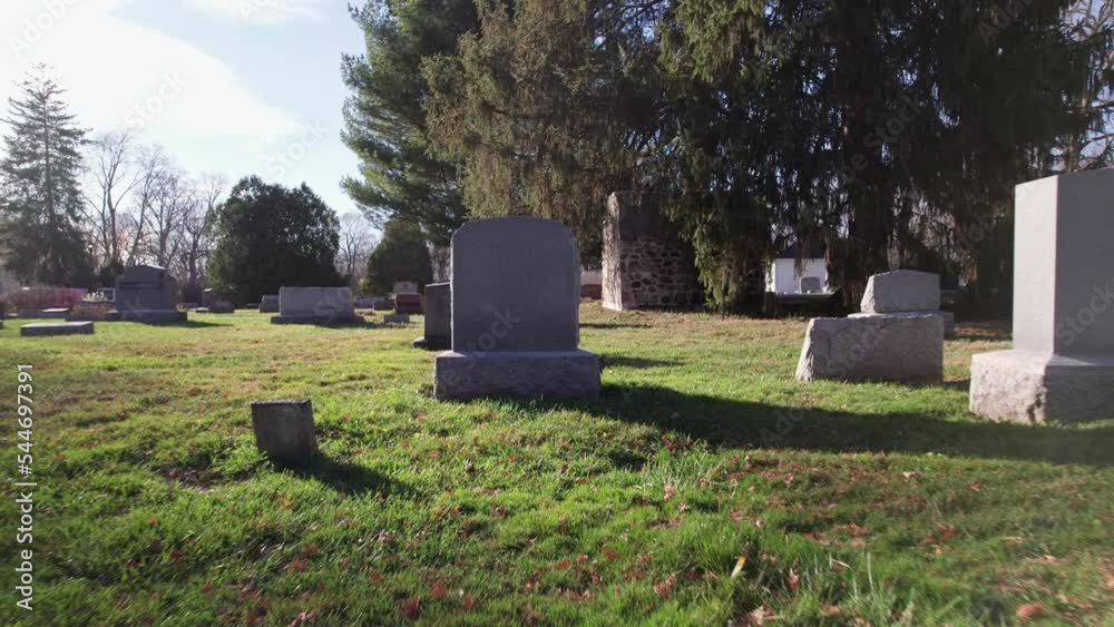 Moving point of view shot through cemetery burial ground, full of ...