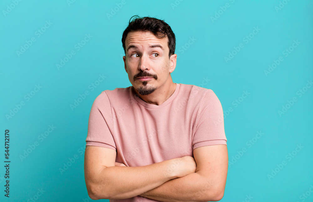 shrugging, feeling confused and uncertain, doubting with arms crossed ...