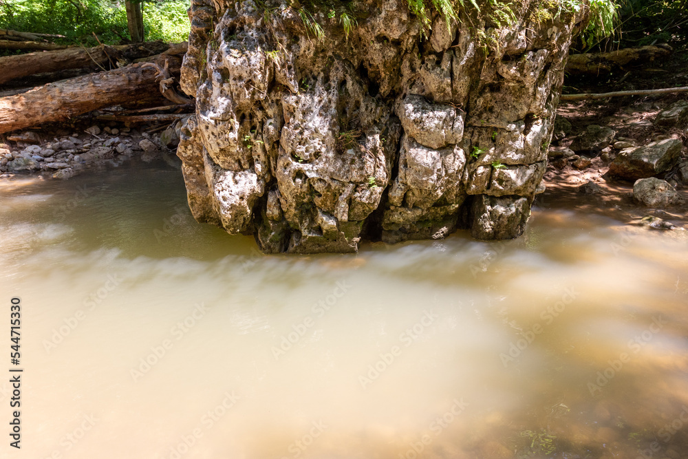 The bed and canyon of a mountain river, shallow by the middle of the ...
