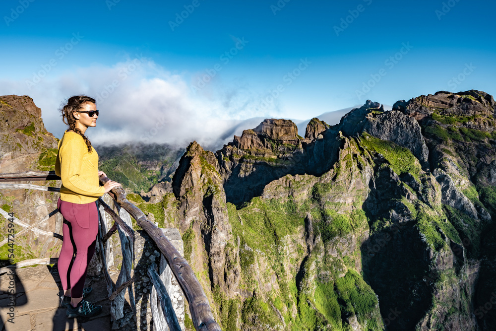Woman enjoying the mountain scenery of Pico Ruivo from a viewing ...