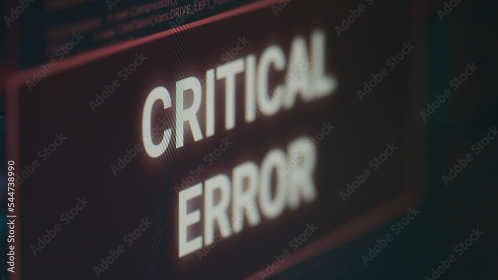 Computer displaying critical error message flashing on screen after cyber crime attack and ...