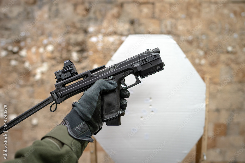 Futuristic pistol with a silencer and a red dot sight. Stock Photo ...