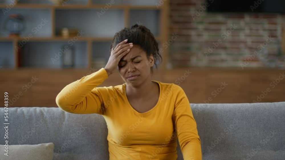 Young upset african american woman suffering from headache attack ...