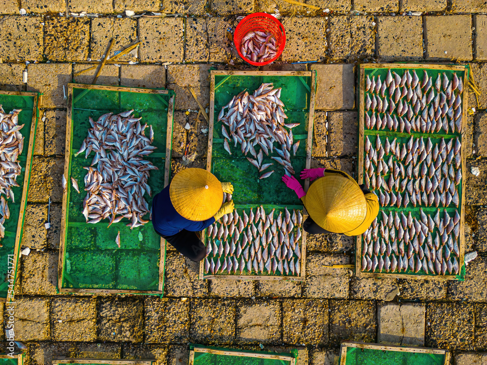 Top view fisherman in fishing village.They was drying fresh fish on a ...