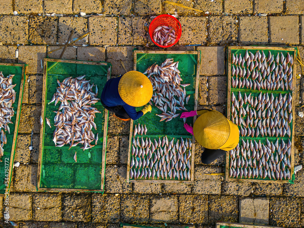 Top view fisherman in fishing village.They was drying fresh fish on a ...