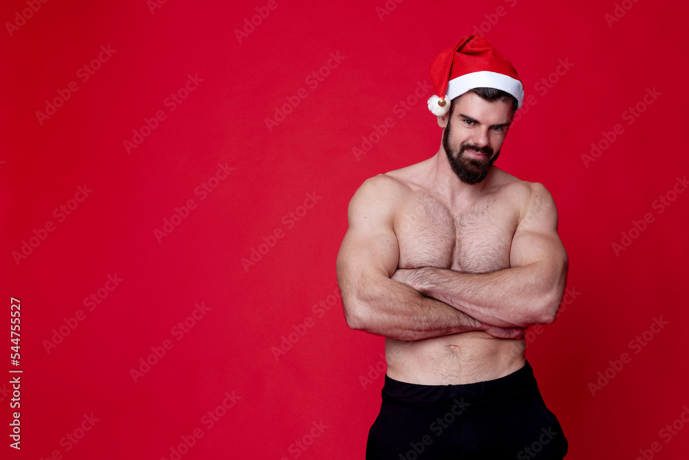 Sexy santa, young shirtless bodybuilder wearing a christmas hat ...