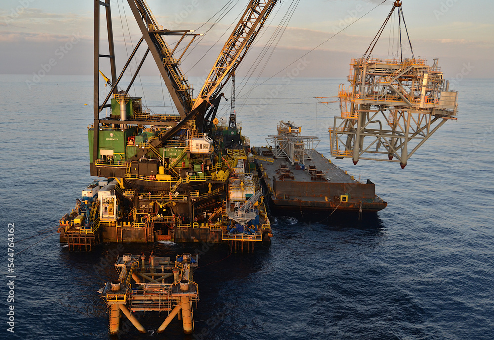 Offshore construction -workers prepare a platform jacket for a riser ...