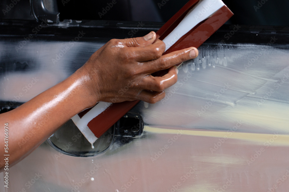 Standard auto repair shop is repairing and repainting the car after the ...