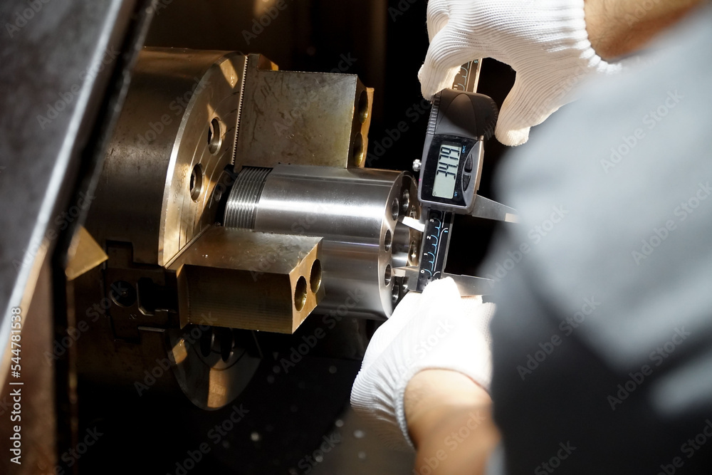Quality control manufacturing.Hands of an engineer measures a metal ...