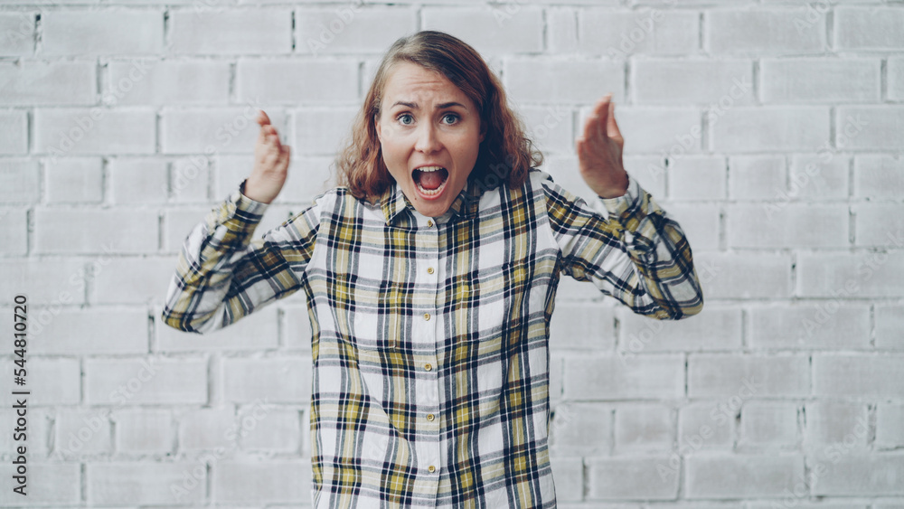 Portrait of stressed young woman screaming and gesturing expressing ...