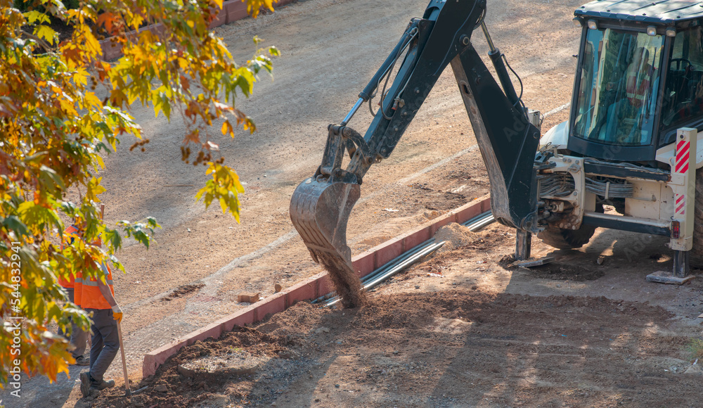 Pavement construction, laying concrete curbs in the foundation ...