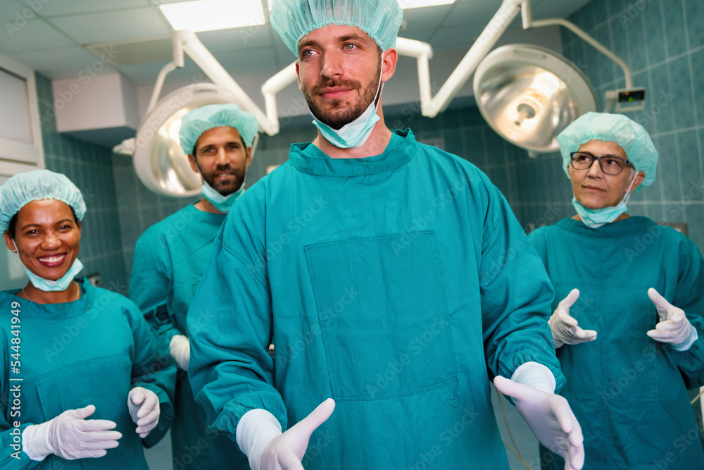 Successful team of surgeon standing in operating room, ready to work on ...