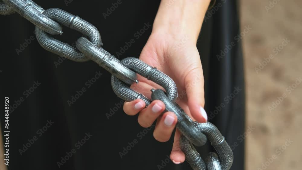 Close up portrait fantasy goth woman holding pulling iron chains ...