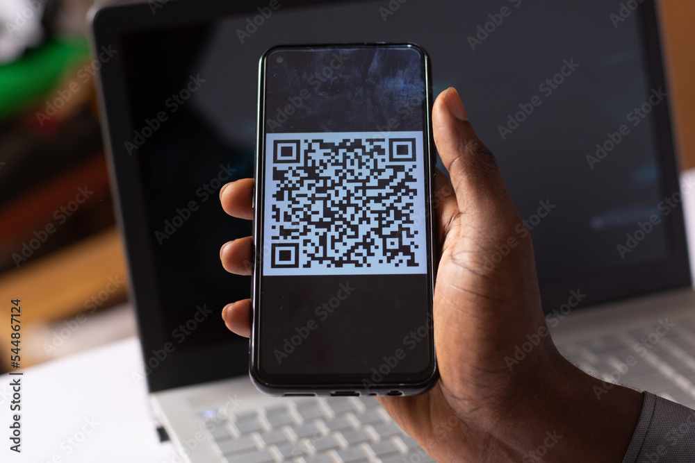 person holding a phone with a QR code on the screen 스톡 사진 | Adobe Stock