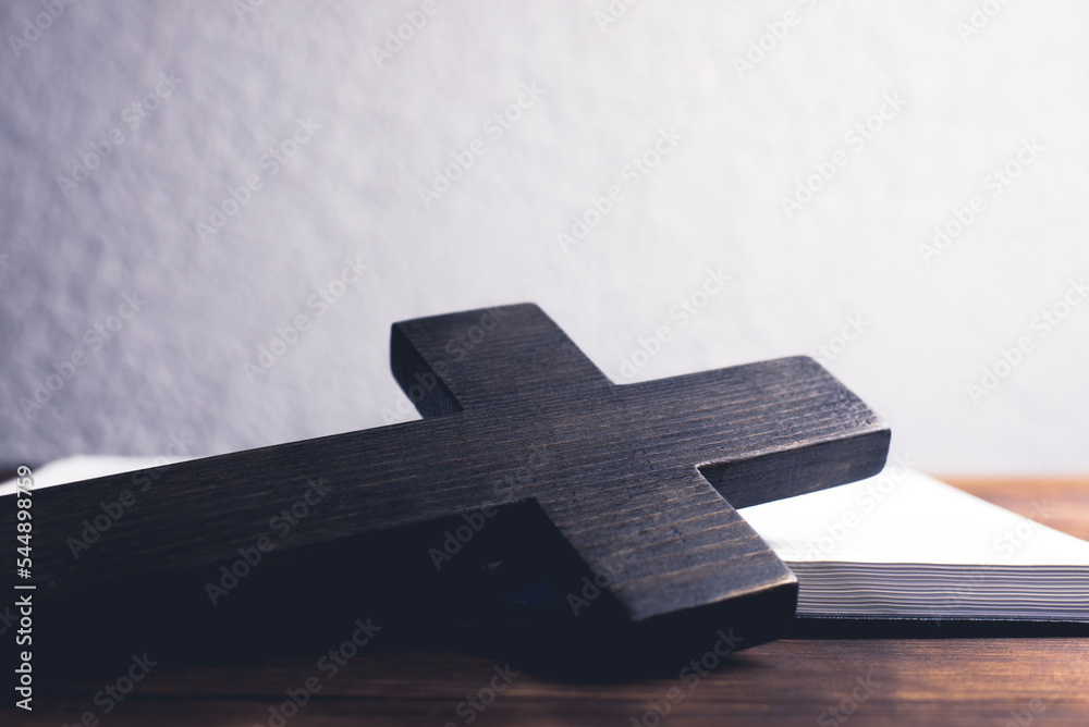 The cross of Jesus. Crucifixion on the Holy Bible. Prayer Stock Photo ...