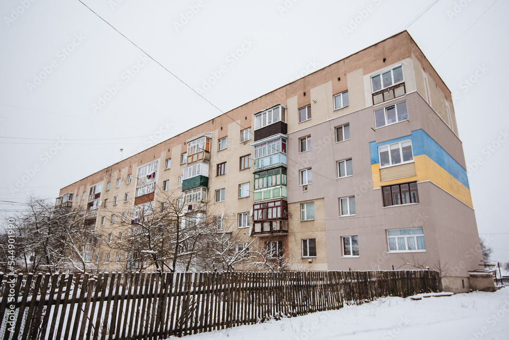 Winter cityscape. Yellow Blue flag of Ukraine on an apartment building ...