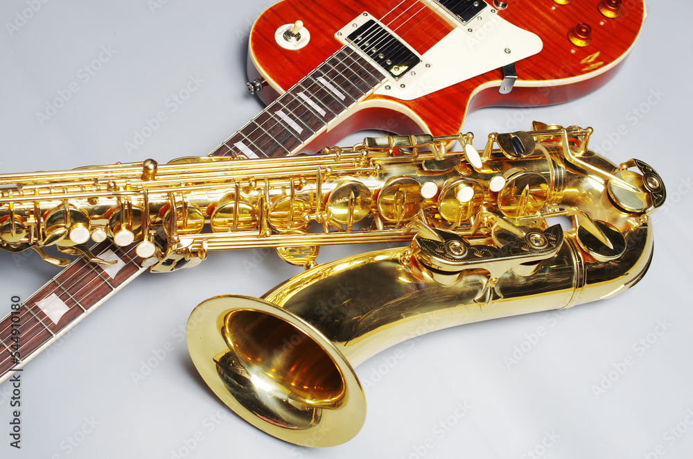 Electric guitar and golden saxophone on a light background. Stock Photo ...