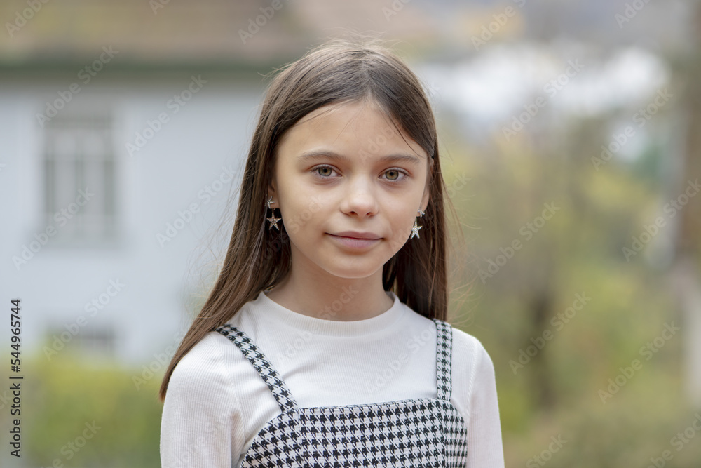 Street portrait of an 11-year-old beautiful and neat schoolgirl girl ...